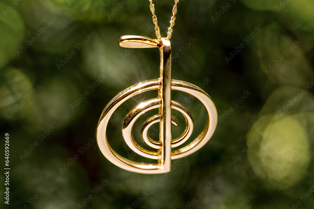 Golden pendant with Reiki symbol Cho ku rei on a gold chain with a ...