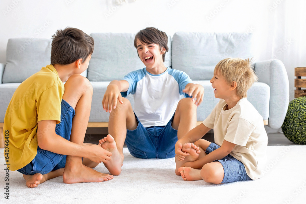 Happy positive children, tickling on the feet, having fun together, boy ...