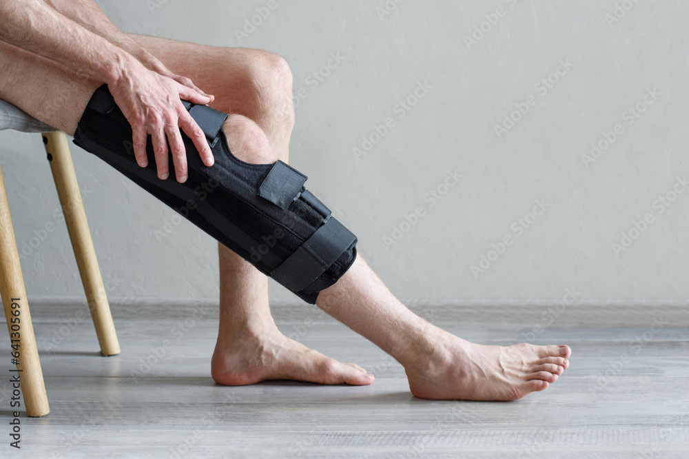 Knee Brace on male leg on grey background. Orthopedic Anatomic Orthosis ...