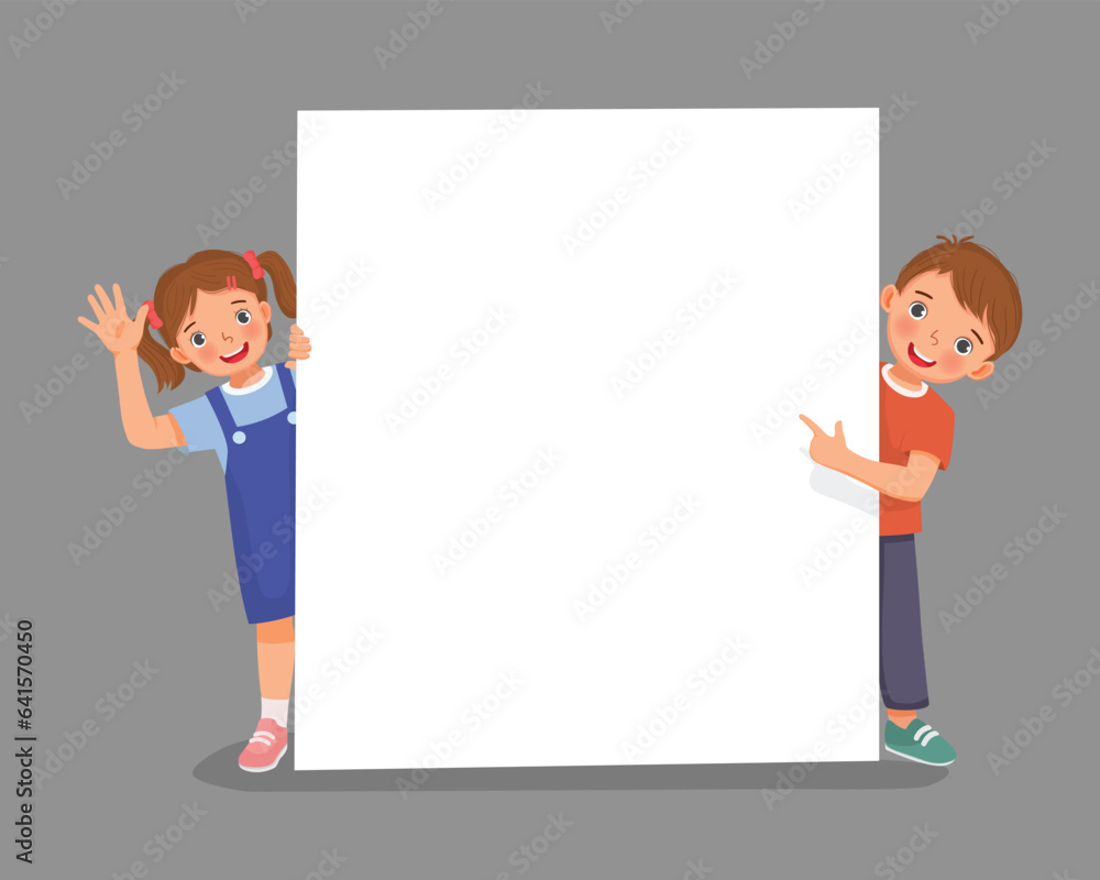 Kids standing behind empty banner peeking and pointing finger over the ...