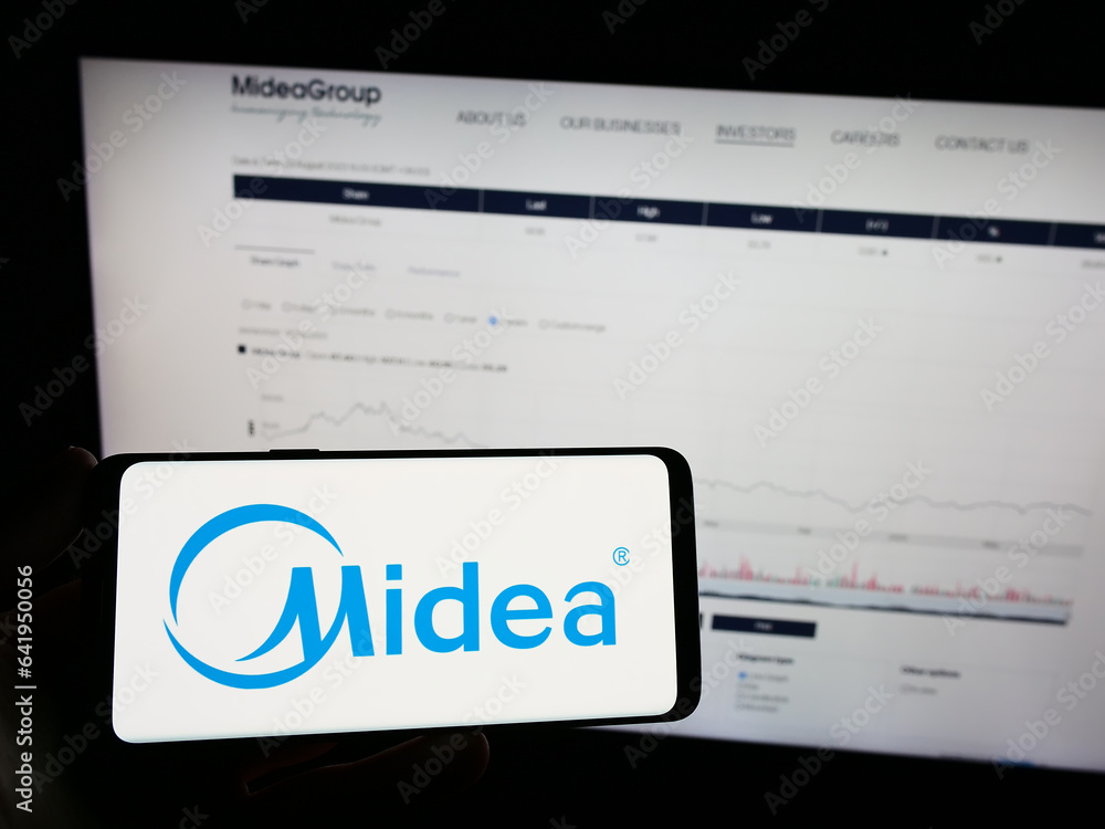 Stuttgart, Germany - 08-28-2023: Person holding mobile phone with logo of Chinese home ...