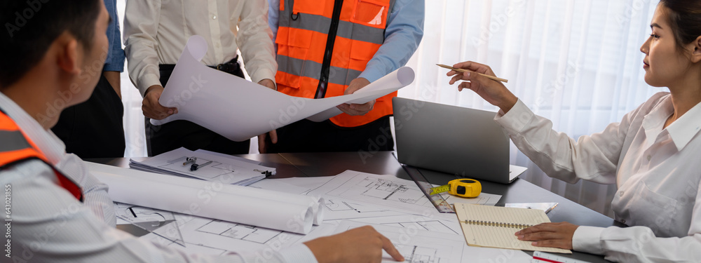 Engineer partner drawing and working on blueprint design together on ...