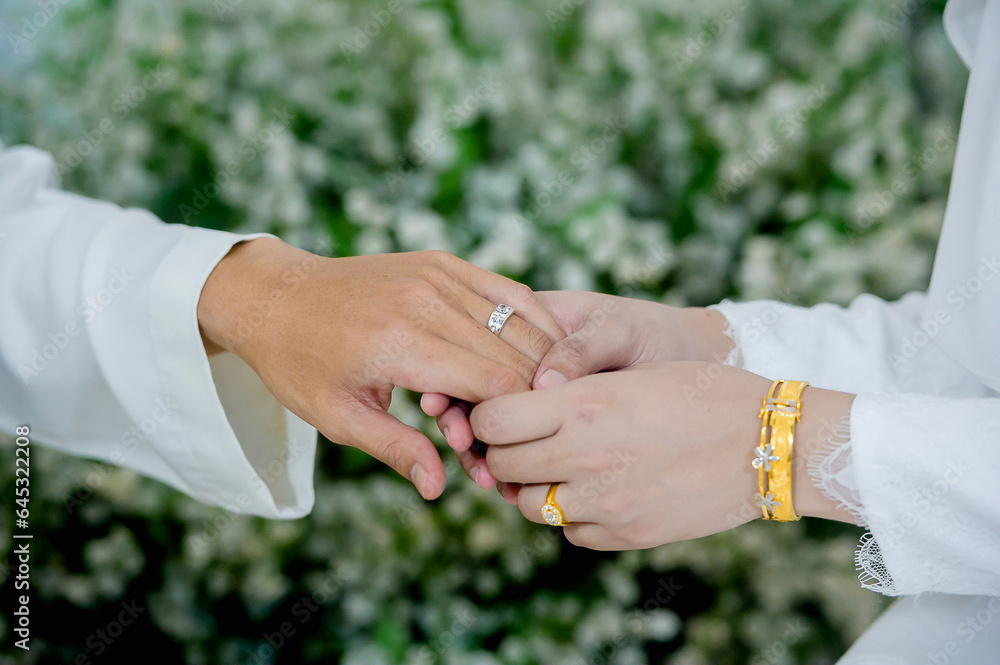 muslim groom in white suite hold hangs finger of muslim bride.concept ...