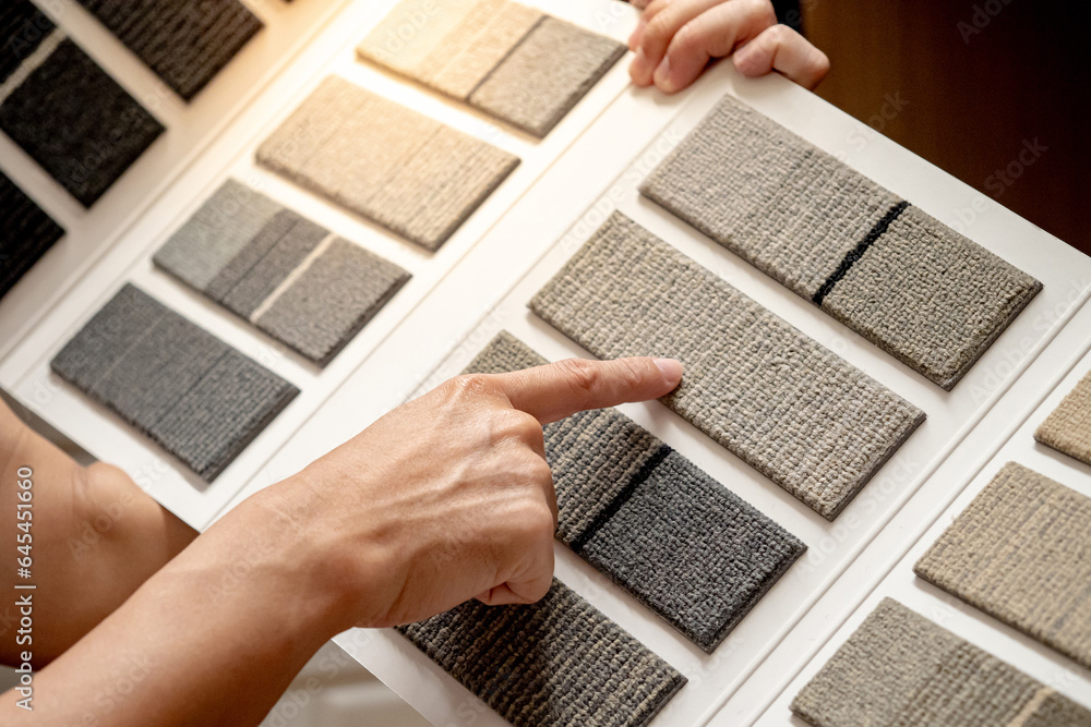 Foto de Stock Designer hand pointing on fabric tile carpet samples ...
