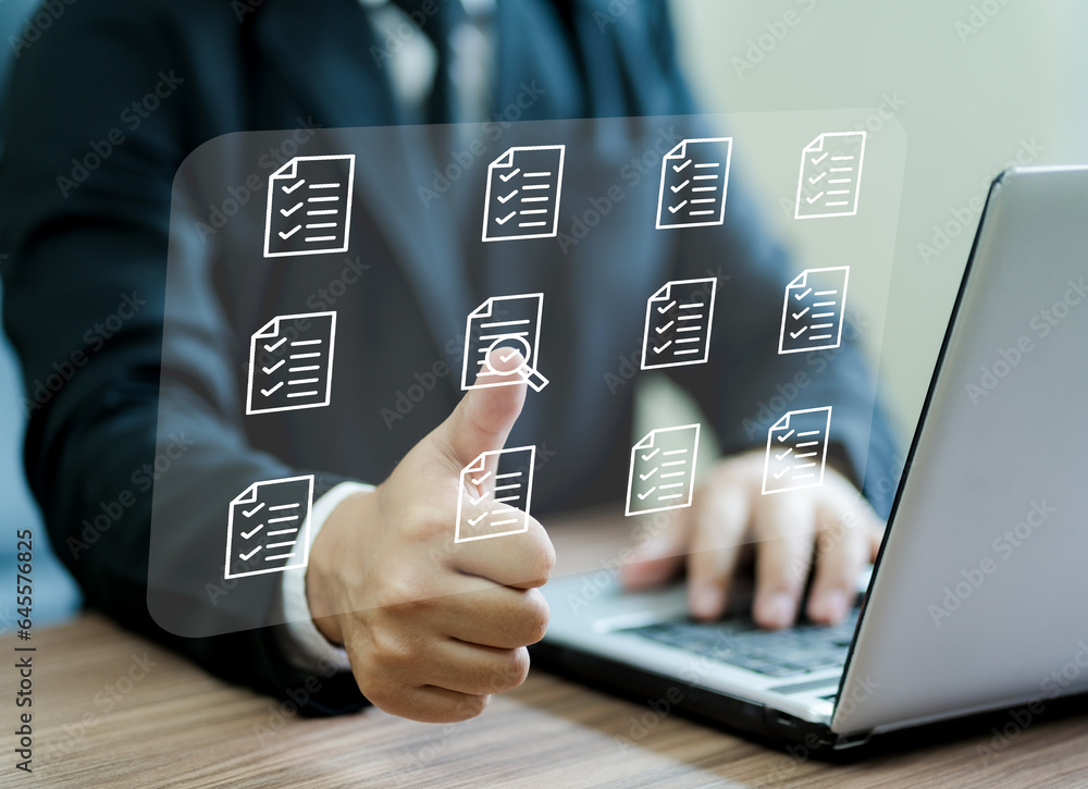 Businessman's hands checking items on documents to manage data ...
