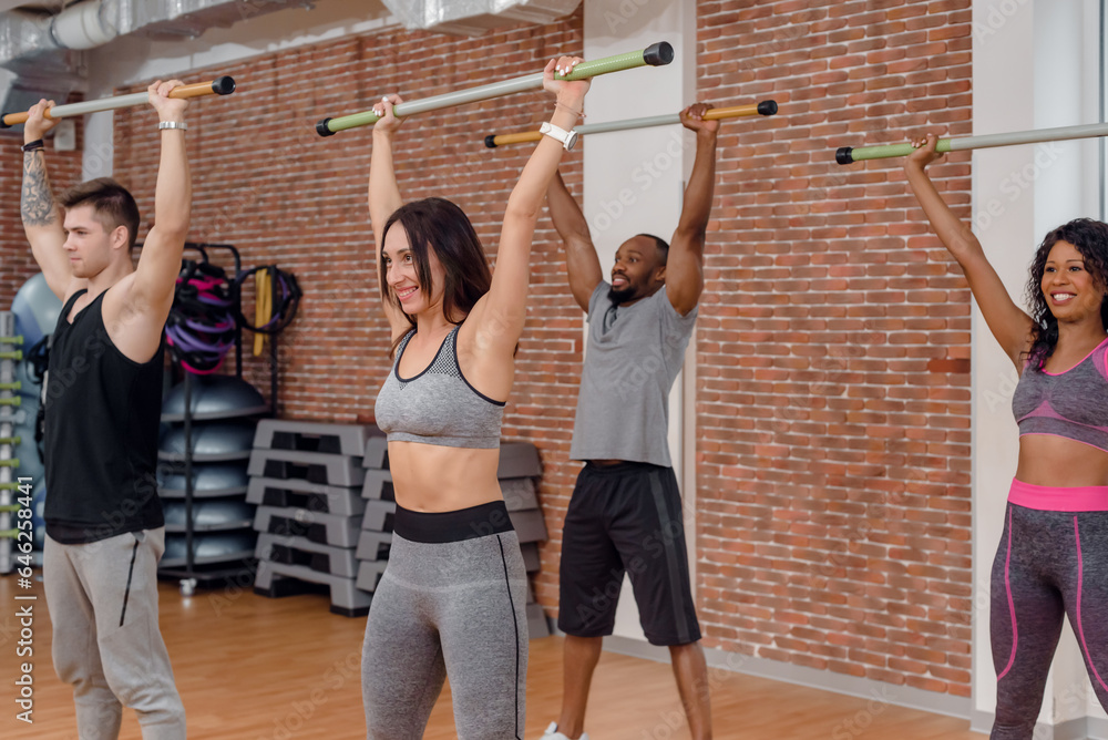 Foto de Stock Diverse team of happy cheerful sporty people lifting bars ...