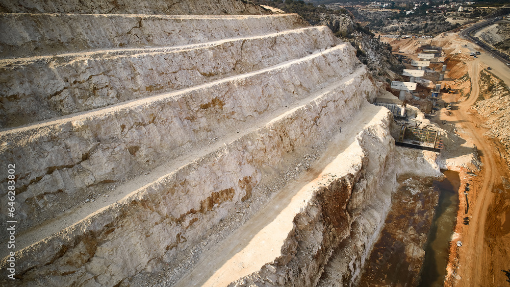 Aerial view of highway ledges under construction after drilling and ...