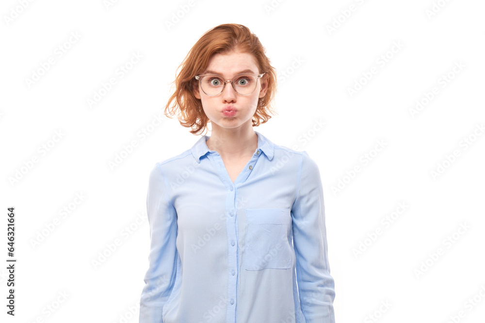 Portrait of young redhead woman puffing cheeks with funny face isolated ...