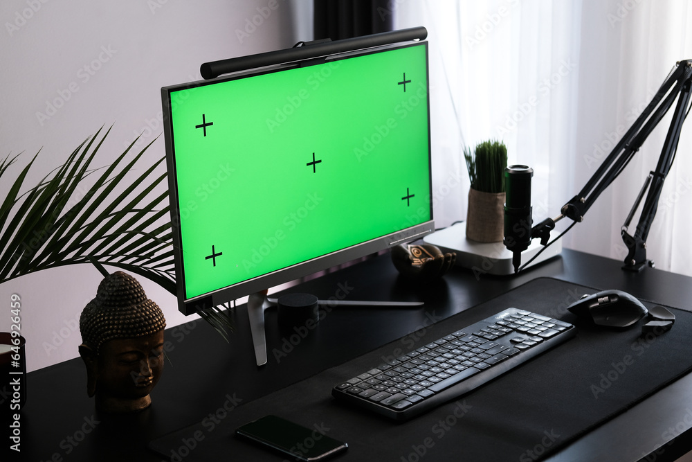 Workspace, monitor with chromakey. Green monitor screen in a modern ...