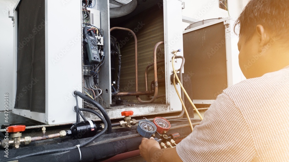HVAC system service technician using measuring manifold gauge checking ...