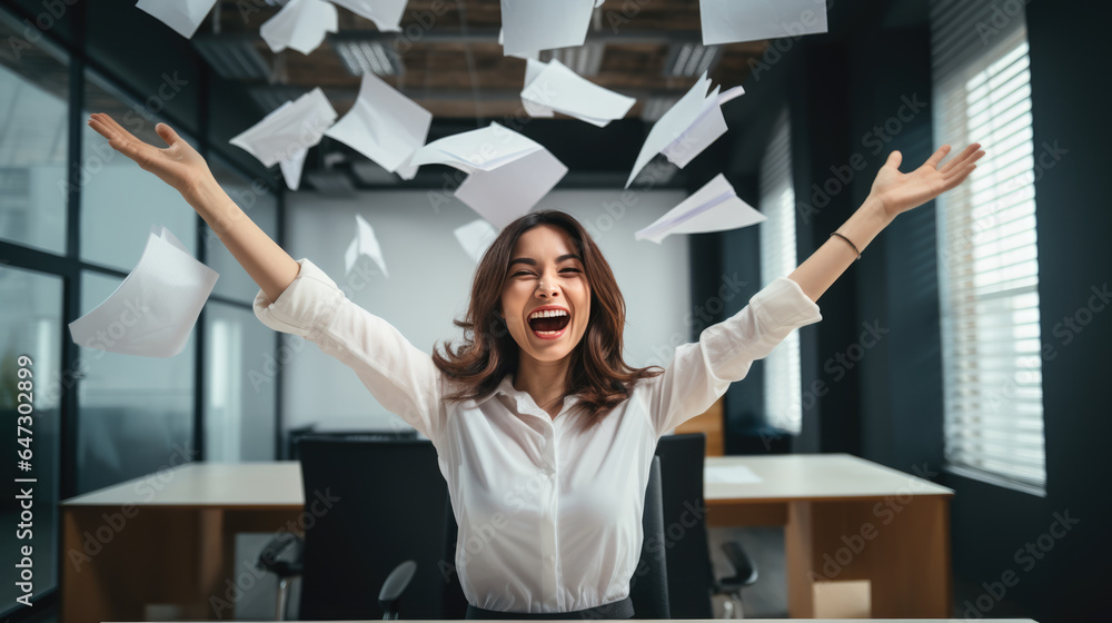 Happy businesswoman throwing papers in the air as a sign of victory and ...
