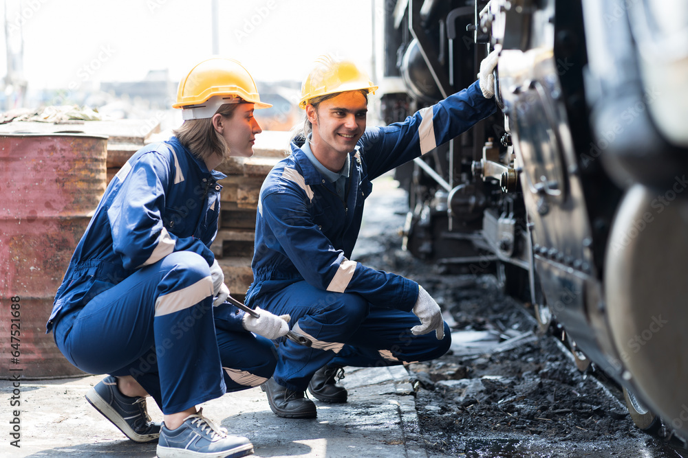 Photo Stock Male and female engineer maintenance locomotive engine ...