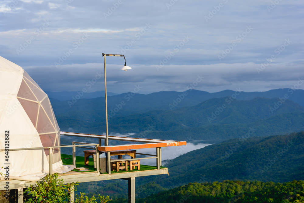 Dome tent for camping and beautiful landscape on hill in rainy season ...
