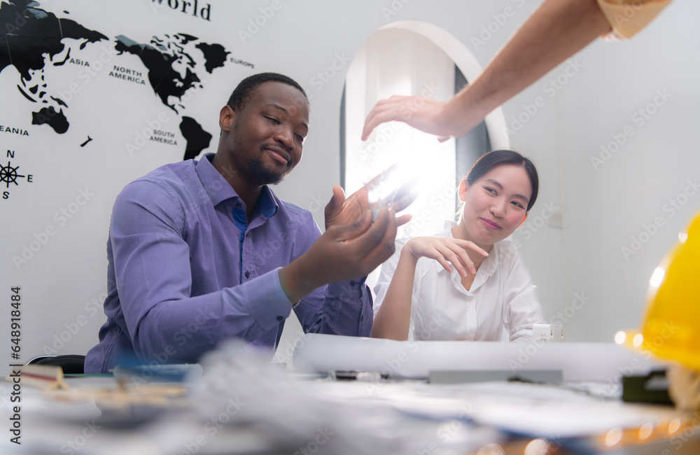 Foto de Stock Multiethnic team of architects and designers are meeting ...