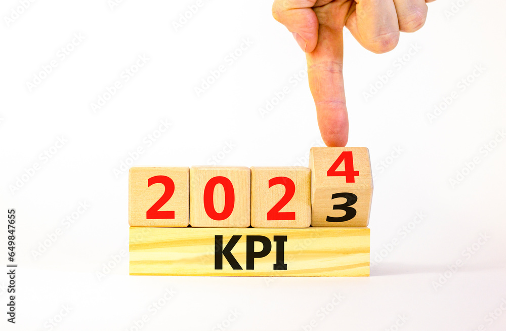 KPI, key performance indicator symbol. Businessman turns wooden cubes ...