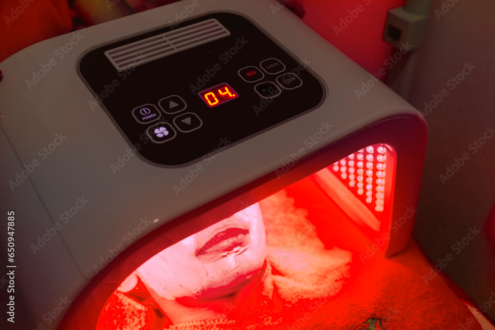 A female patient undergoes red LED light or RLT therapy for skin ...