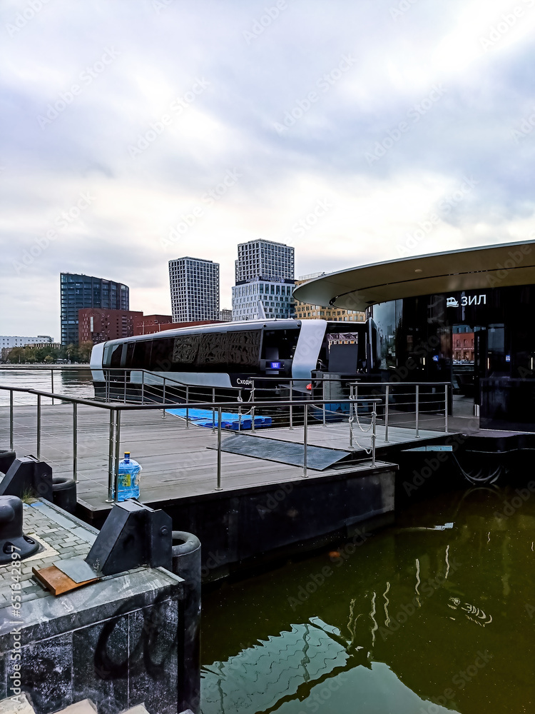 Electrical ship on Moscow River parked on pier. Aquabus boat is an ...