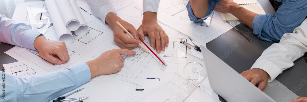 Architect or engineer working on building blueprint, contractor ...