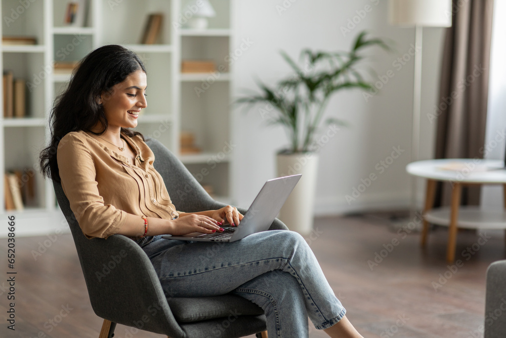 Freelance concept. Happy hindu lady using computer working online ...