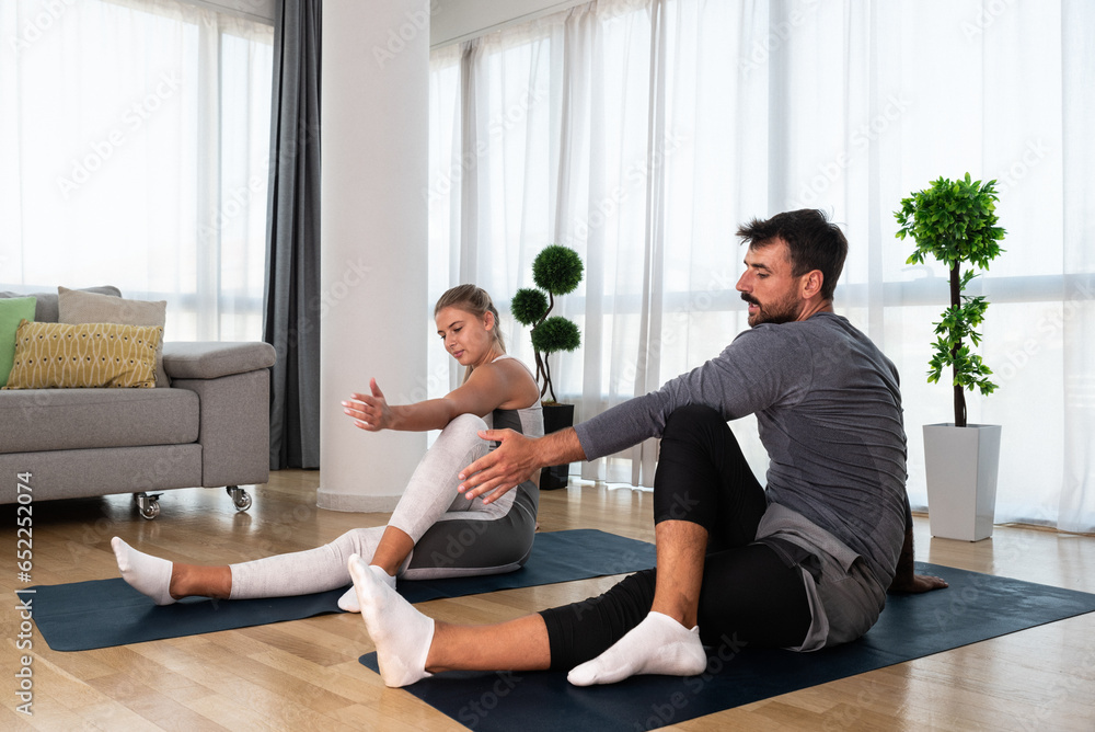 Couple exercising together. Man and woman in sportswear doing workout ...