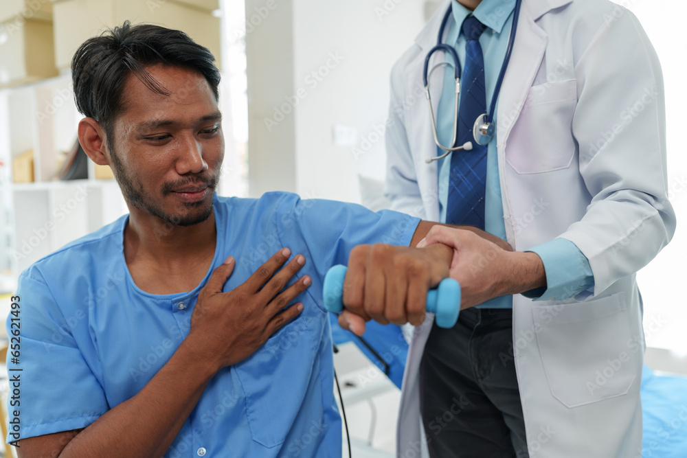 The doctor counsels the patient about pain in the muscles of the arms ...