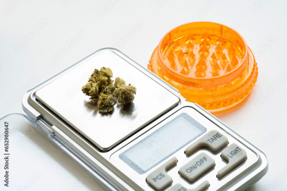 Weighing buds of medical cannabis marijuana on a electronic scale next ...