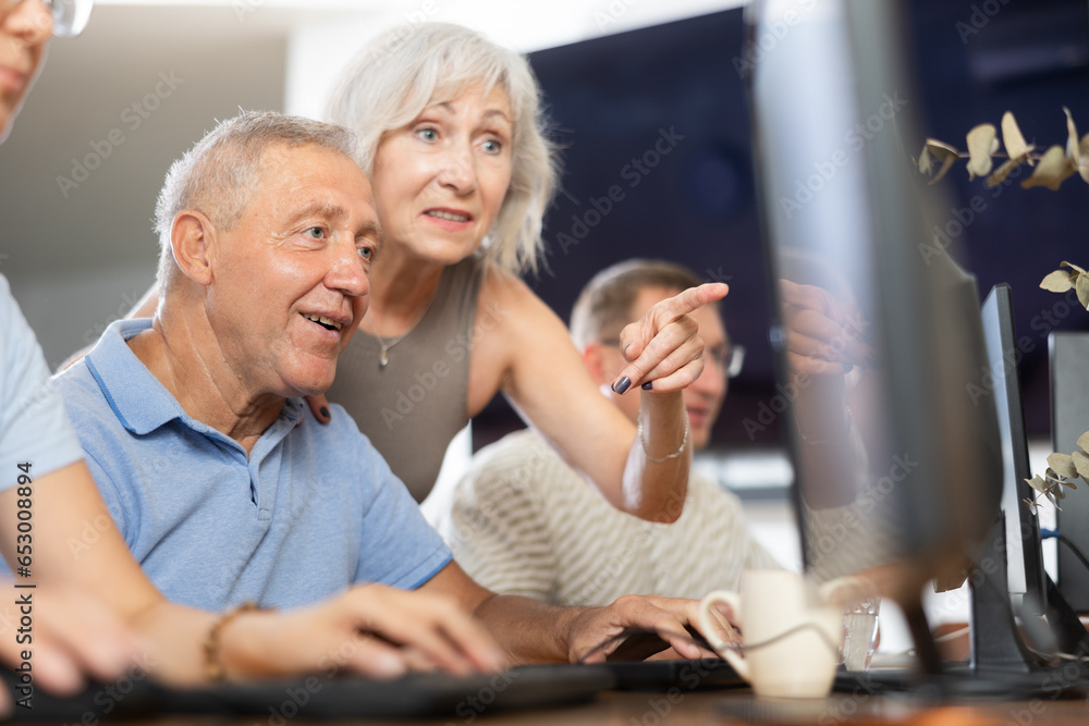 Smiling friendly older female mentor explaining something to motivated ...