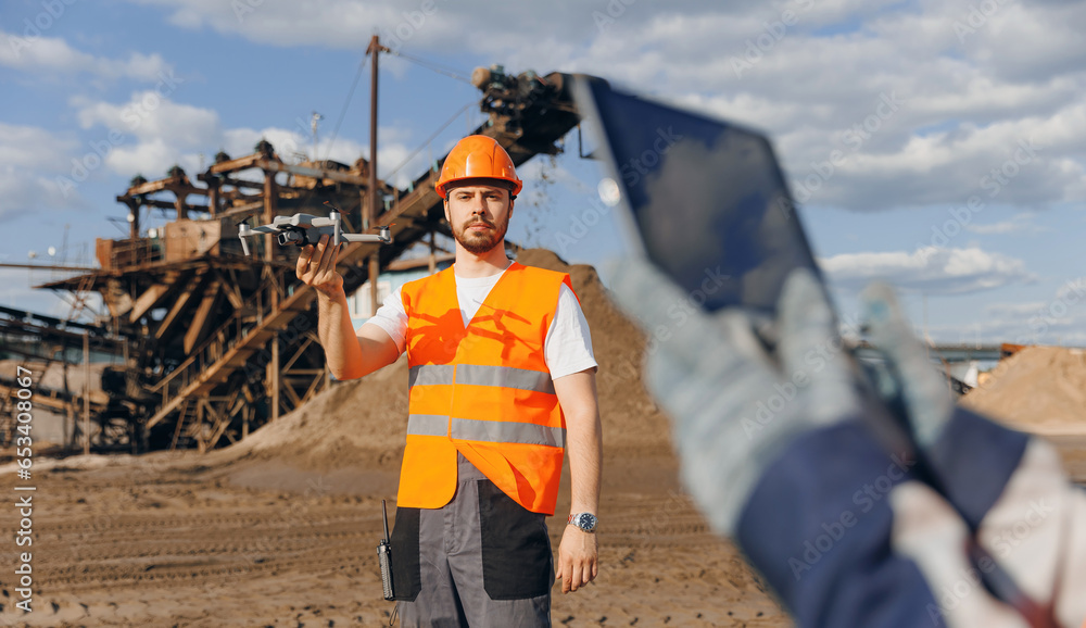Foto de Stock Engineer man worker control drone over open pit mine coal ...
