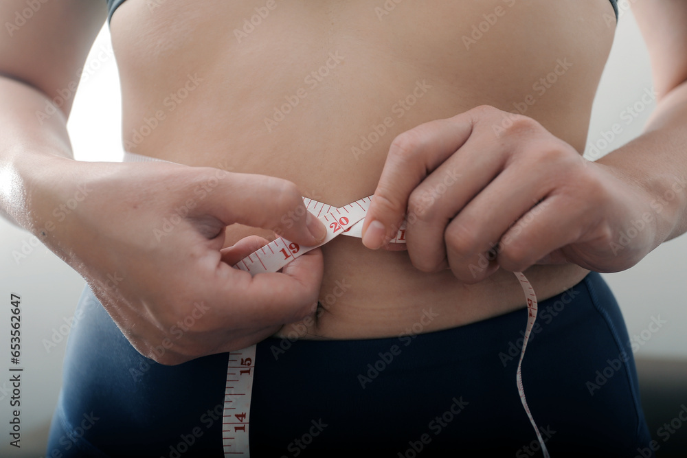 Women body fat belly. Obese woman hand holding excessive belly fat. diet lifestyle concept to ...