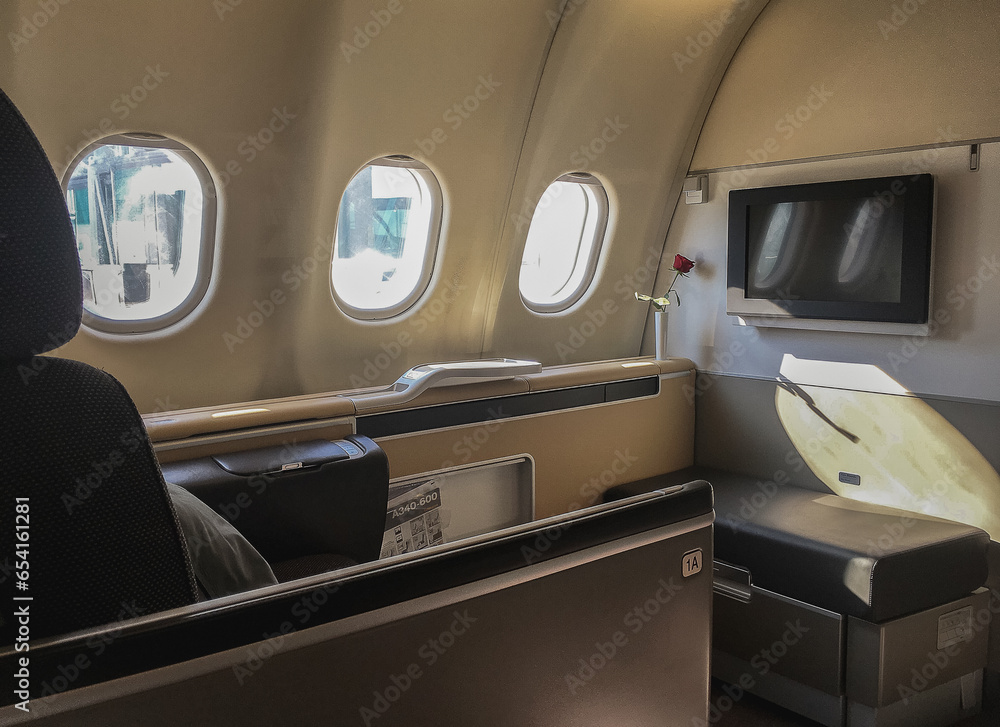 View into First Class cabin with single and double lie flat suite seat ...