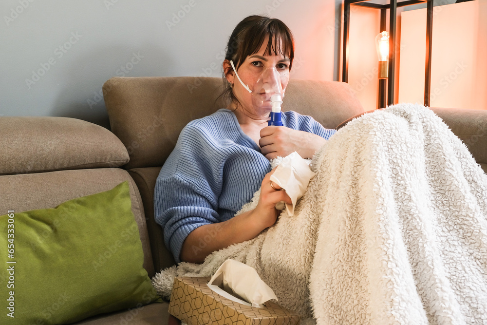 Woman makes inhalation nebulizer at home. Holding a mask nebulizer ...
