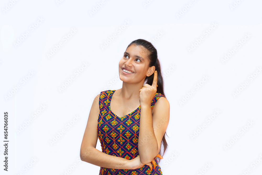 Portrait of a happy Indian teenage girl in deep thinking, got idea ...
