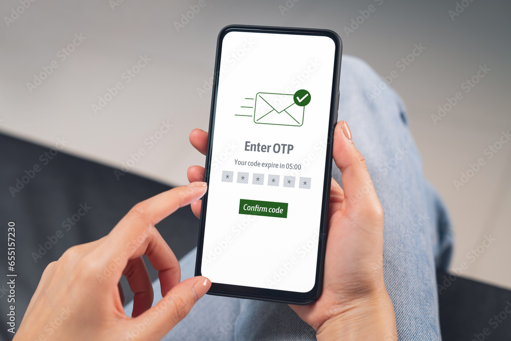 Hand using smartphone and mobile OTP secure verification on send to ...