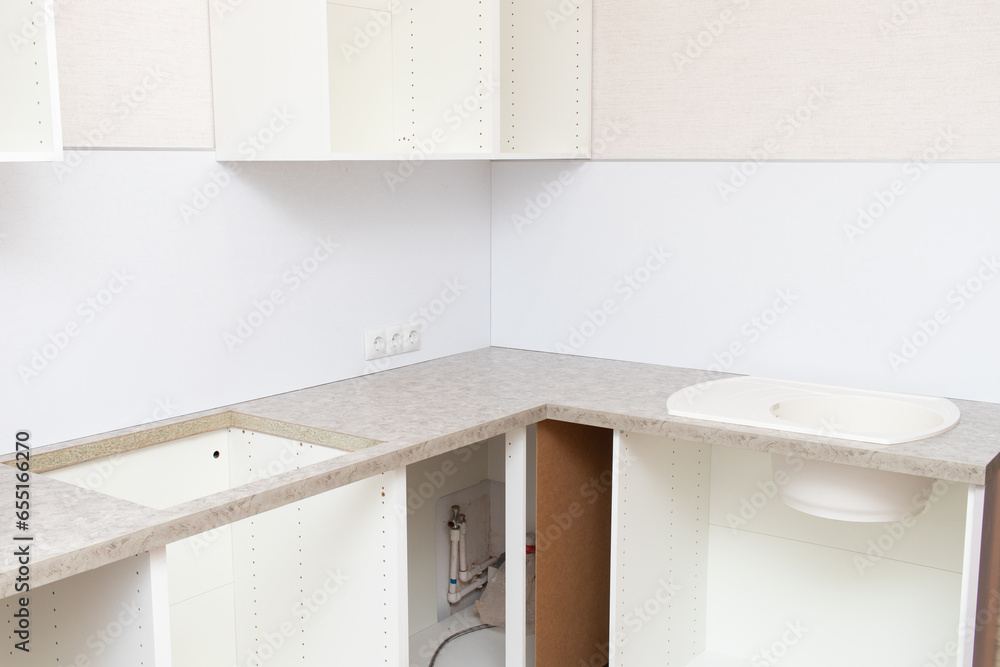 Modular kitchen from chipboard material on a various stages of ...