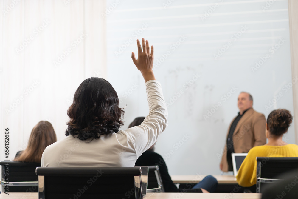 Businessman rises hand up for the question in the diverse employees ...
