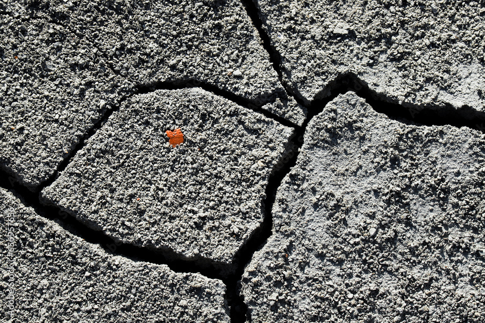 Texture of dried up cracked grey mud and clay. Brick material. Top view ...