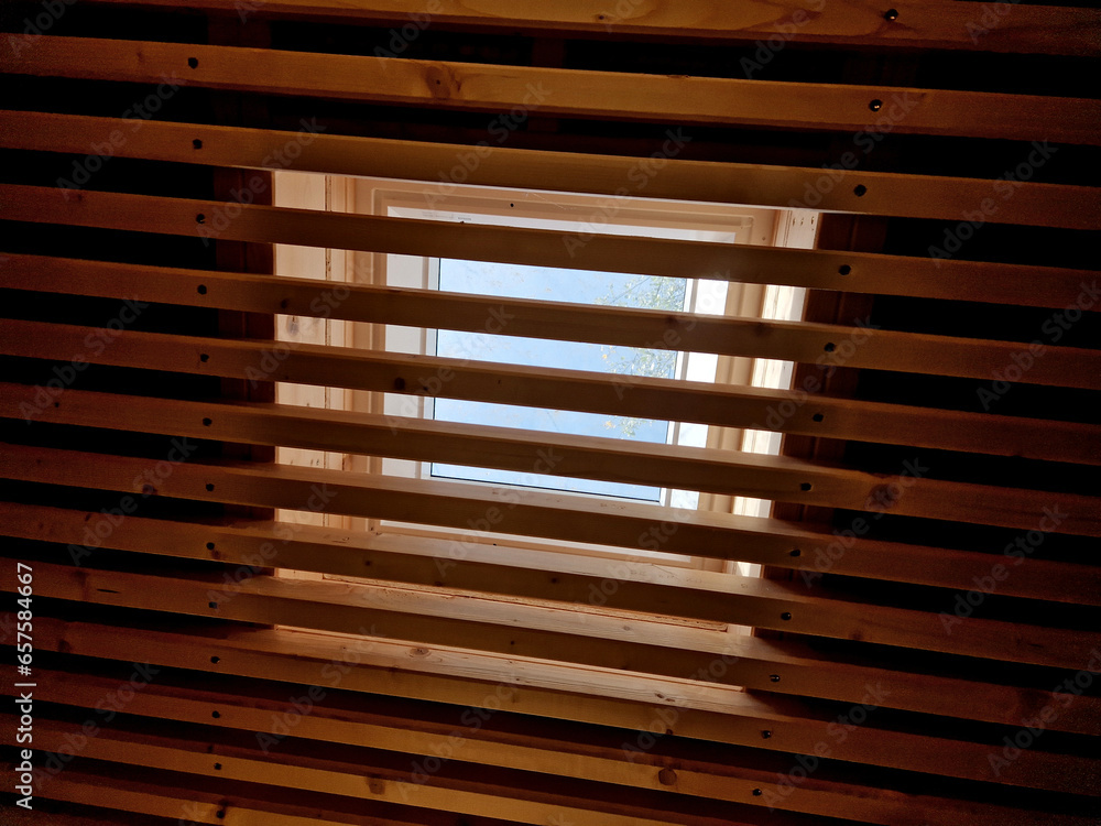 ceiling window under wooden battens in the soffit of the ceiling. a ...