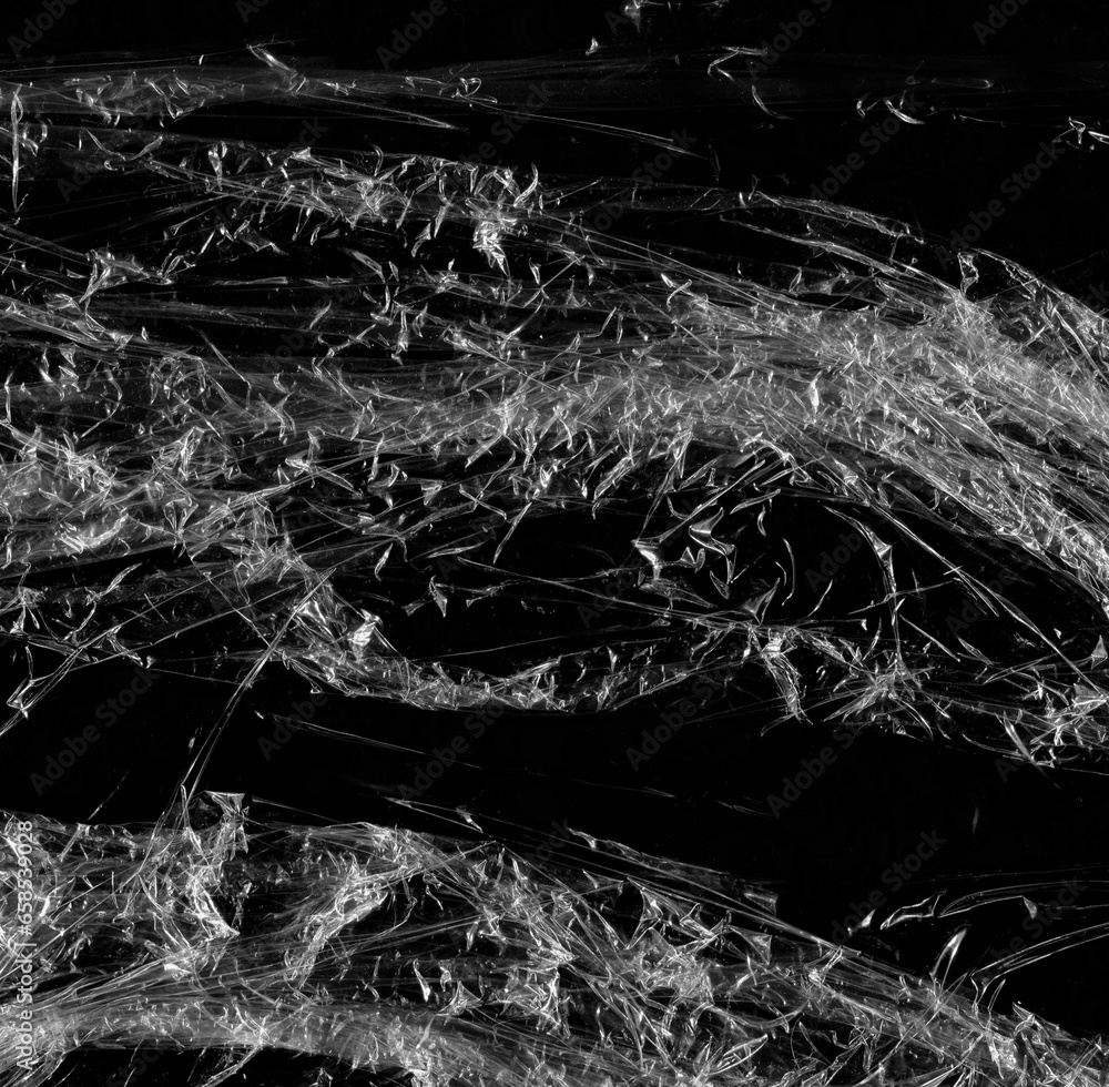 Wrinkled plastic wrap texture on a black background wallpaper. Royalty ...