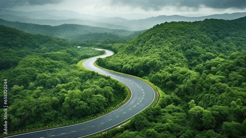 Aerial top view beautiful curve road on green forest in the rain season ...