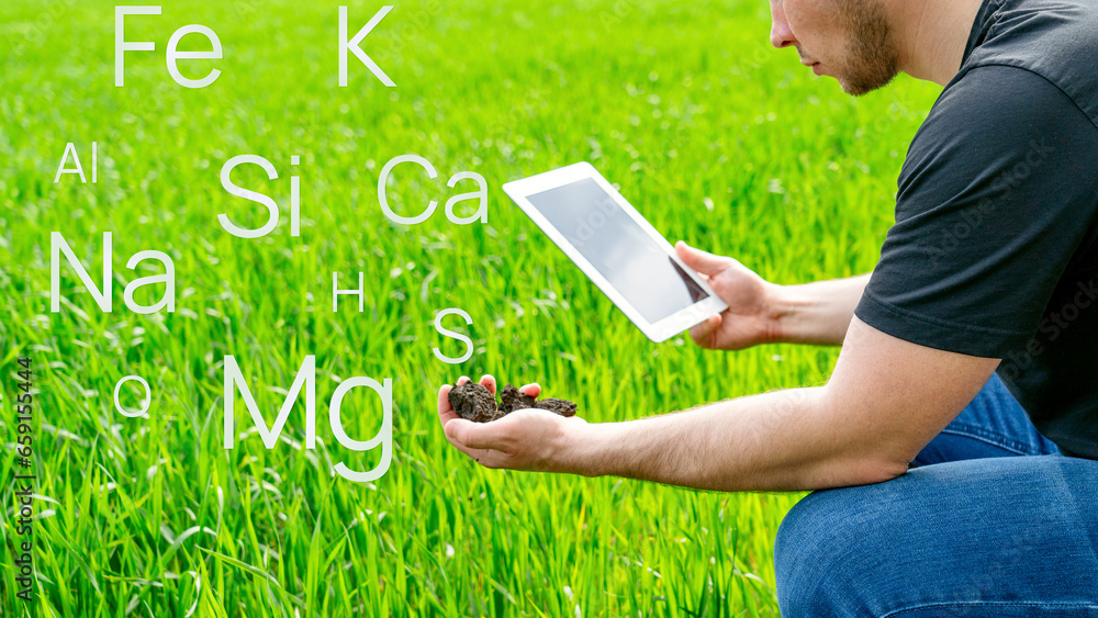 Farmer in field looking at result of soil analysis. Against background ...