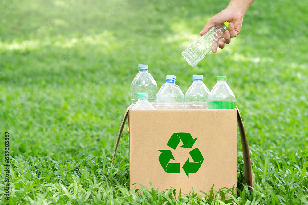 Man hand keep plastic bottle into paper box at public park for ...