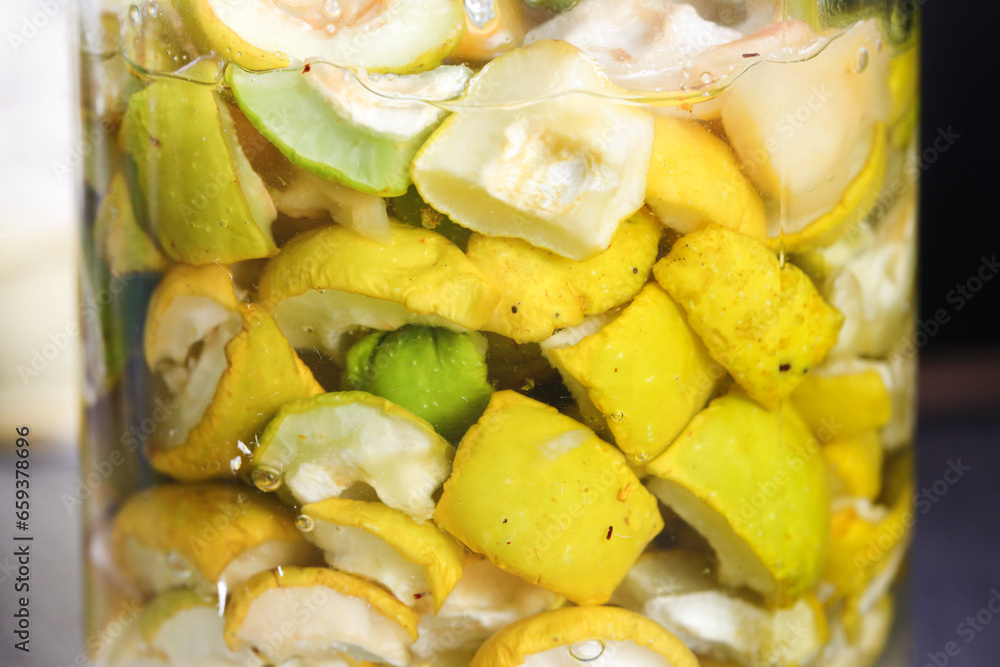 Quince in glass jar. Sugar covered fruits releases juice. Marinating ...