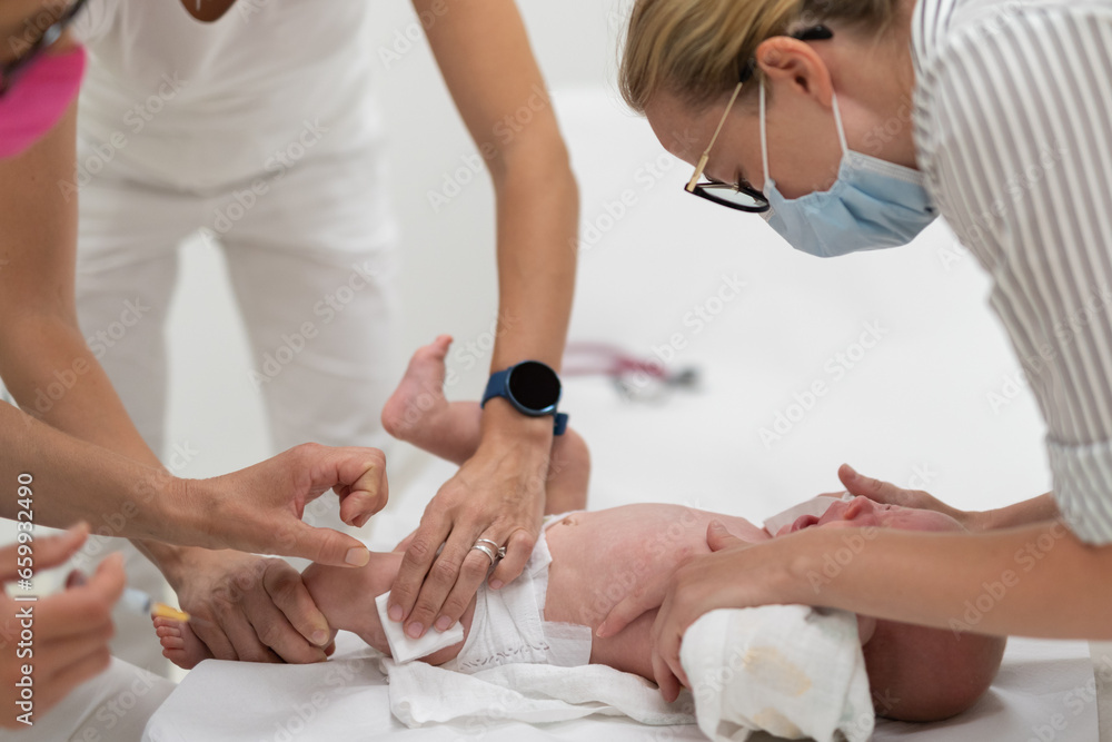 Baby beeing vaccinated by pediatrician in presence of his mother ...