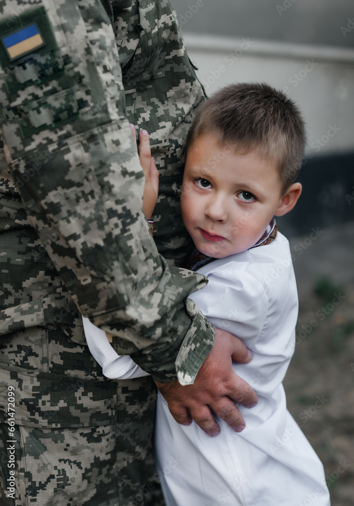 Teen son says goodbye to her military with his eyes closed. Son hugs a ...
