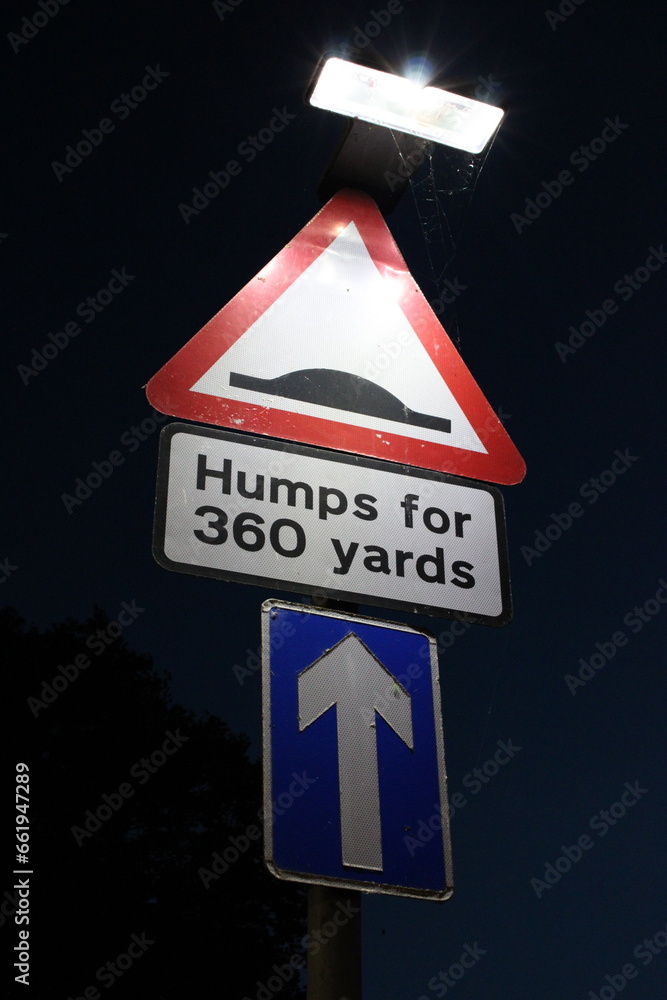Hump road sign with text "Humps for 360 yards" with one way sign taken ...