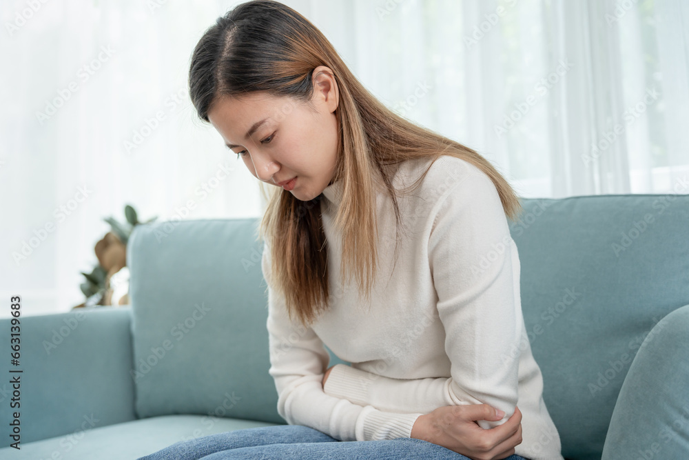 Stock-Foto „stomach ache. Asian women have abdominal pain, indigestion, gastritis, menstrual ...