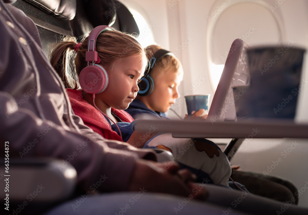 Adorable little boy girl travel by plane. Cute Kids sit by window of an ...