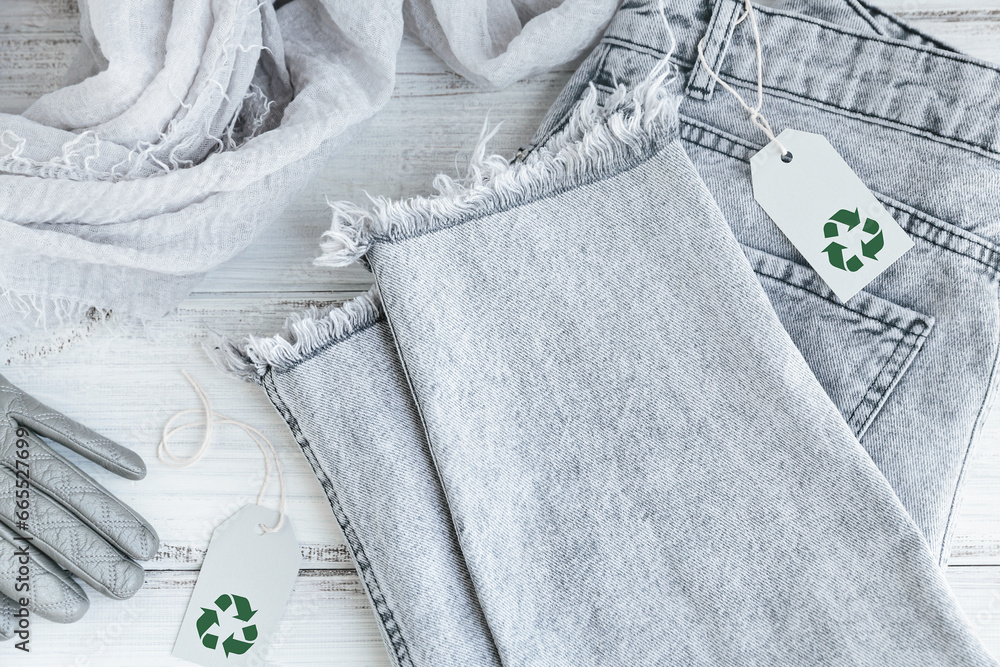 Top view over woman outfit and paper tag with Recycling symbol on white ...