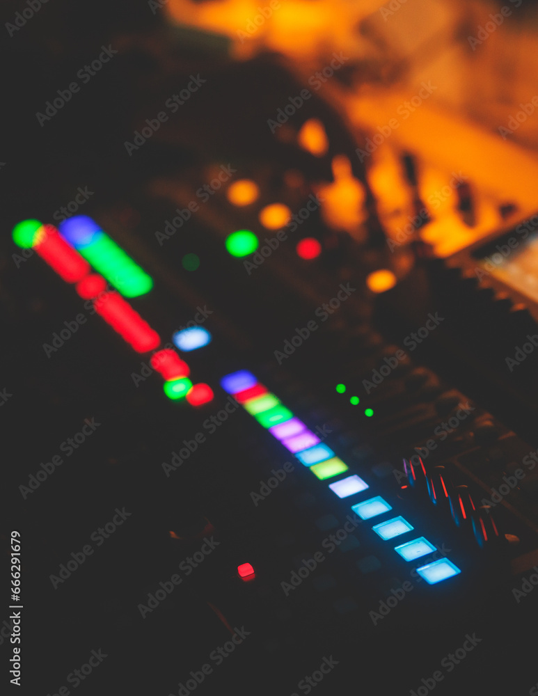 View of lighting technician operator working on mixing console ...