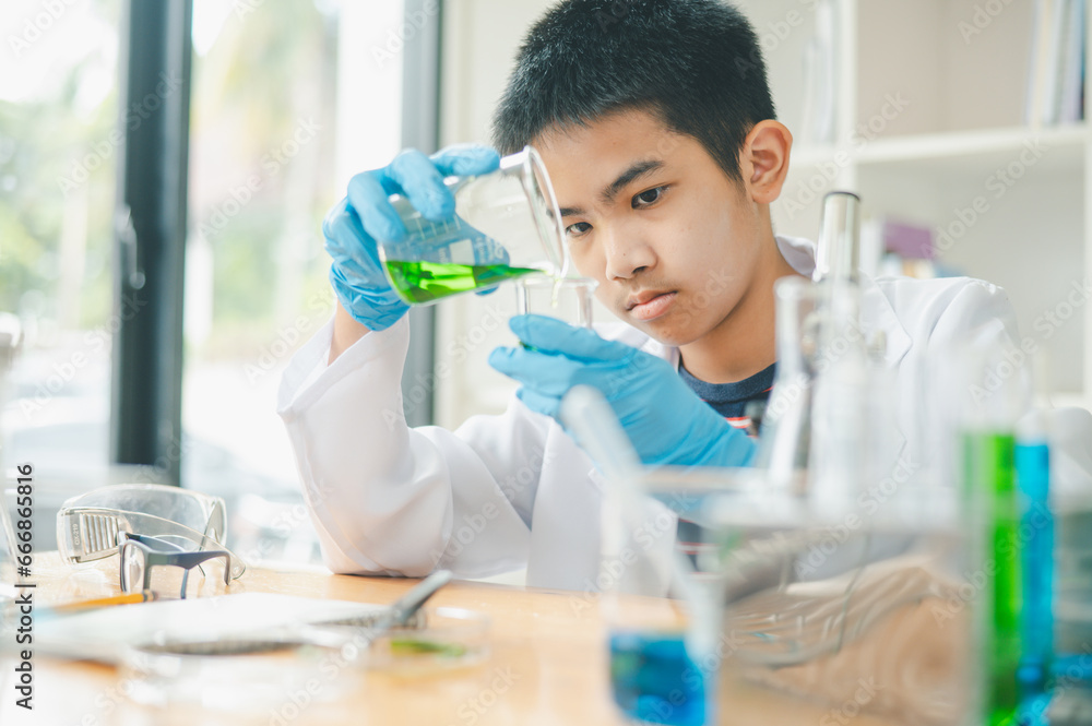 Asian male science students looking through a microscope and tests of ...